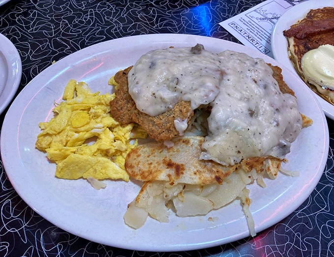Country fried steak smothered in peppery gravy alongside golden scrambled eggs &ndash; the breakfast that fueled America's greatest generation.