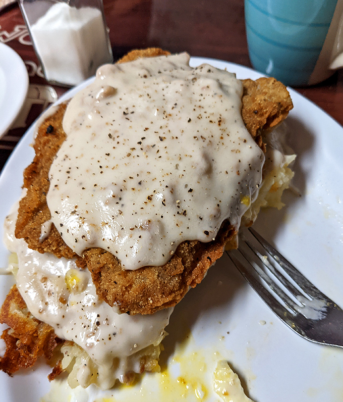 Country fried chicken smothered in gravy that could make a vegetarian question their life choices. This isn't a meal&mdash;it's a commitment.