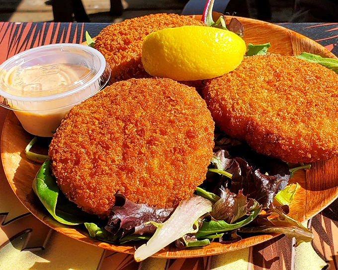 Crab cakes that actually taste like crab. Served on a bed of fresh greens, these golden discs are the coastal equivalent of hitting the culinary lottery.