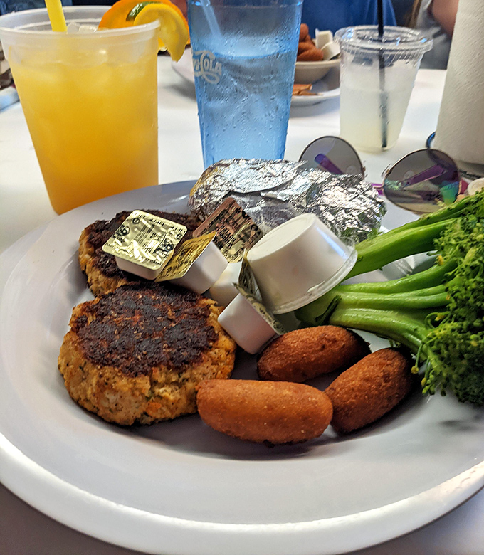 Crab cakes and hushpuppies &ndash; the dynamic duo of Chesapeake cuisine. Notice how the crab cake is mostly crab, not cake &ndash; as nature intended.