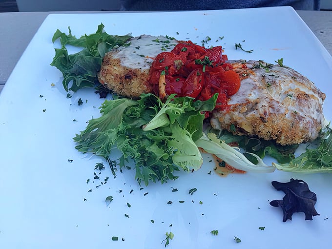 These crab cakes aren't playing around&mdash;all crab business with just enough binding to keep the party together, topped with fresh greens and roasted tomatoes.