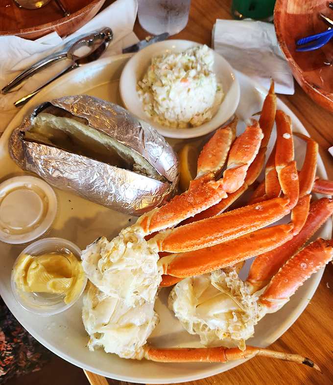 Snow crab legs splayed like a sunburst around a baked potato &ndash; nature's perfect design for both crustacean and dinner presentation.
