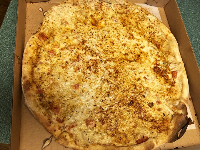 This pizza doesn't need neon signs to announce its greatness. The golden crust and perfect cheese-to-seasoning ratio speak volumes without saying a word.