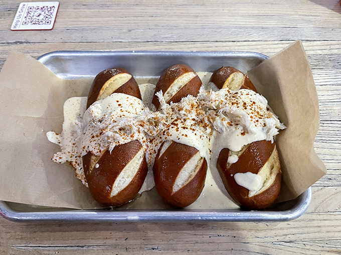 Pretzel perfection meets crab decadence. These soft pretzel bites smothered in creamy crab dip might just be worth driving across state lines for.