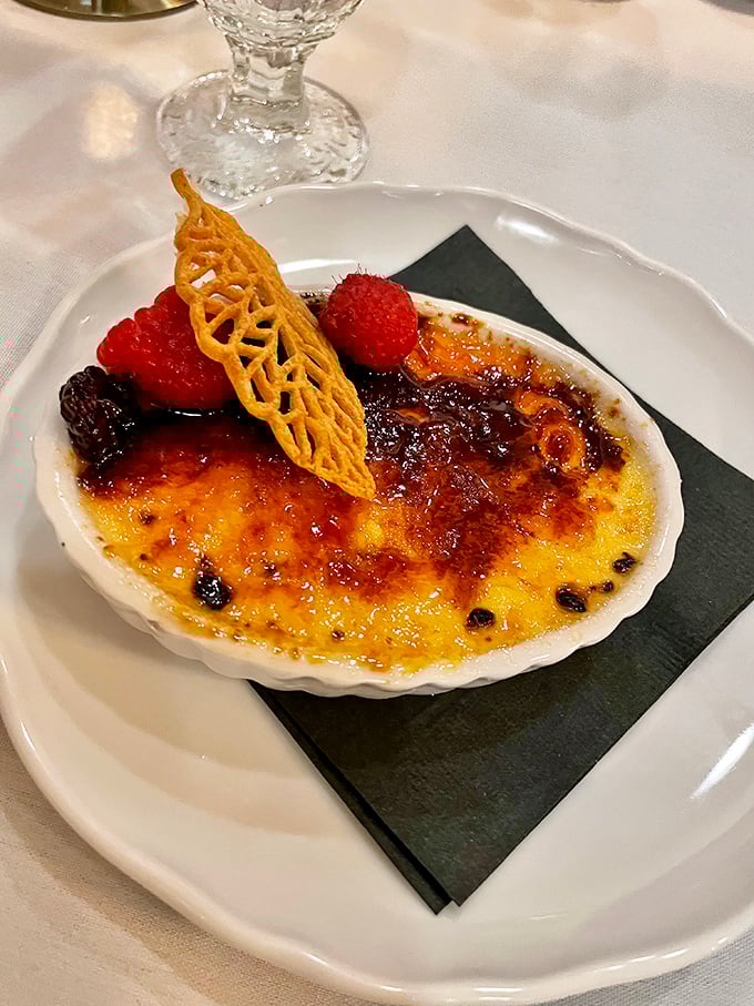 Crème brûlée with that glass-like caramelized top and fresh berries. The sound of cracking into it might be the world's most satisfying percussion.