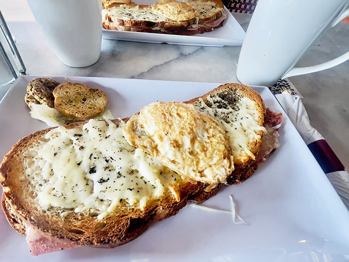 The Croque Monsieur: where ham and cheese transcend their humble origins. That golden top is what breakfast dreams are made of.