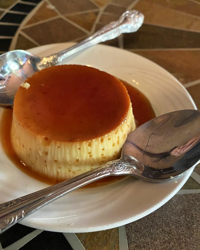 This flan doesn't wobble—it struts. Silky custard crowned with caramel that's witnessed more proposals than a wedding planner.