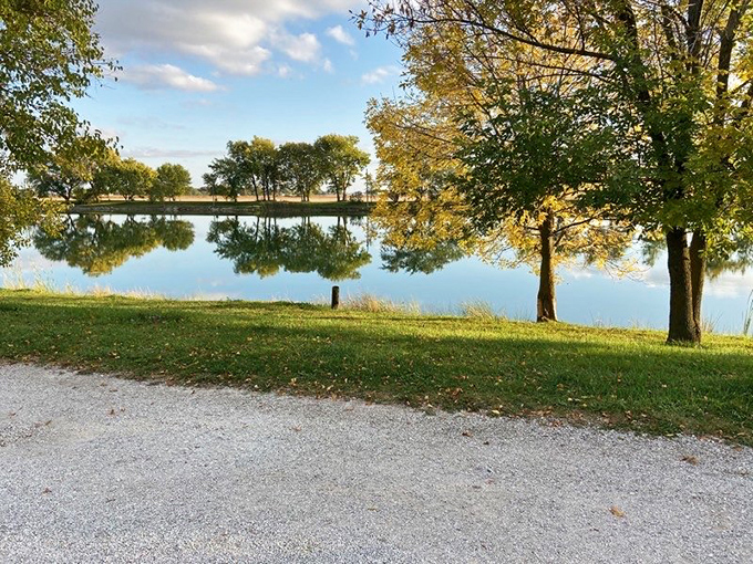 Mirror-like waters reflect golden trees at this serene park &ndash; proof that sometimes the most memorable vacation moments come without admission fees.