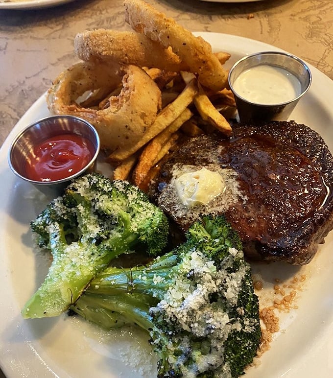 The Delmonico arrives with a pat of butter slowly melting into bison perfection, while Parmesan-dusted broccoli provides the illusion of virtue.