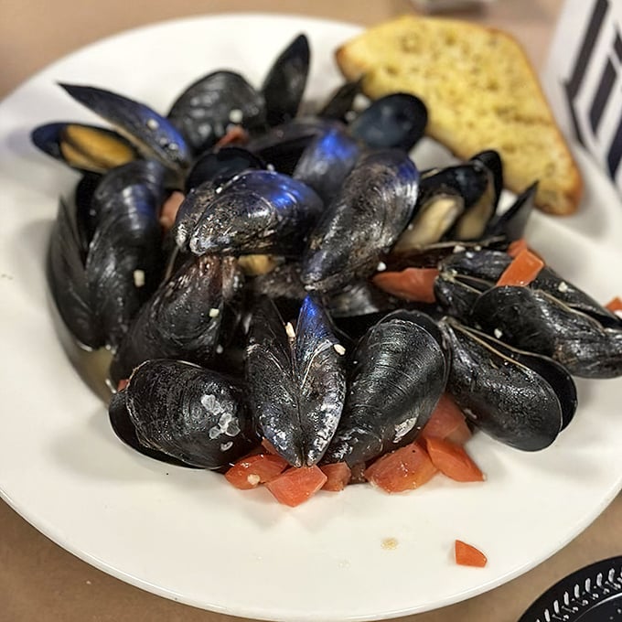 These mussels have clearly been hanging out with some tasty friends&mdash;garlic, tomatoes, and herbs that make the shells perfect sauce-dippers.