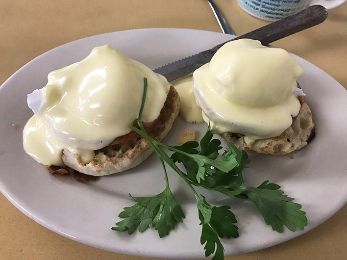 These eggs Benedict aren't messing around&mdash;hollandaise cascading down English muffin mountains with a sprig of parsley standing guard.