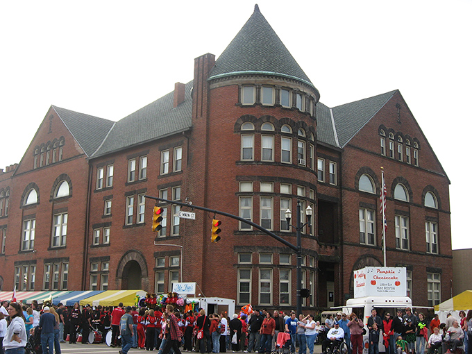 The historic Pickaway County Courthouse stands sentinel during the Pumpkin Show, its distinctive turret and red brick a backdrop to festival merriment.