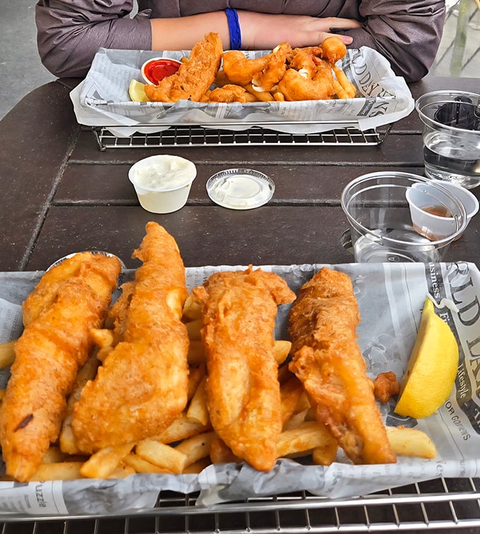 The newspaper might be missing, but nothing else is. Two trays of perfectly fried fish that would make Captain Ahab forget all about that whale.