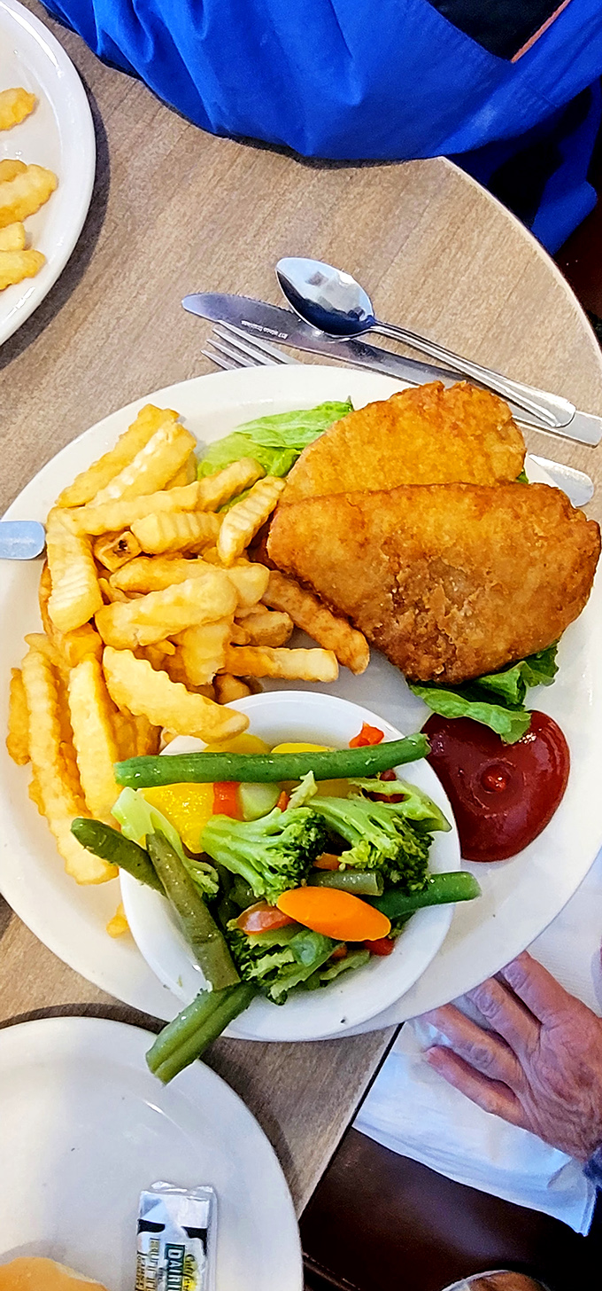 Fish so perfectly golden it practically winks at you, with fries and veggies playing the supporting roles they were born to play.