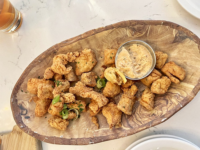 Golden-fried perfection that would make Neptune himself reach for seconds. These crispy fish bites with remoulade are dangerously addictive.