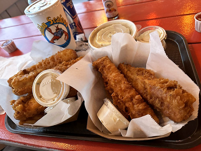 Fish and chips so perfectly golden they deserve their own California sunset. The tartar sauce cups stand ready for their supporting role.