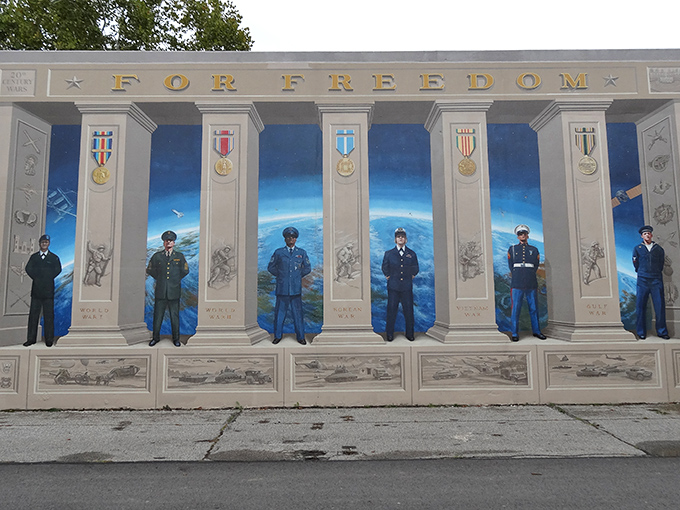 "For Freedom" declares this striking floodwall mural, where military figures stand at attention, part of Portsmouth's 2,200-foot outdoor art gallery.
