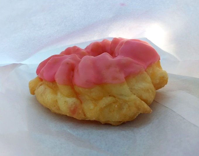 Pretty in pink and perfect for dunking. This French cruller might look delicate, but its airy texture and sweet glaze pack a flavor punch that demands your full attention.