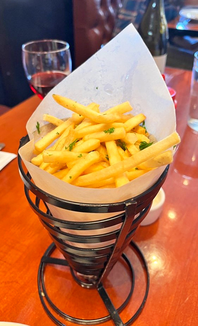 French fries served in a metal cone&mdash;crispy, golden, and ready for their close-up. Potato perfection that demands to be shared.