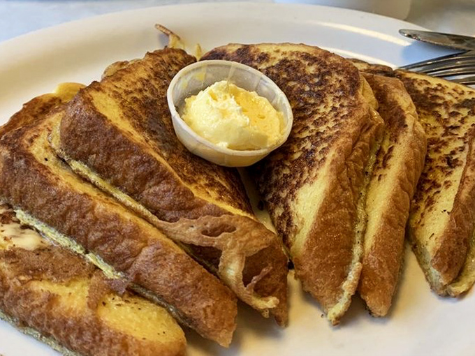 French toast golden enough to make King Midas jealous. That butter cup isn't a suggestion &ndash; it's an essential part of the experience.