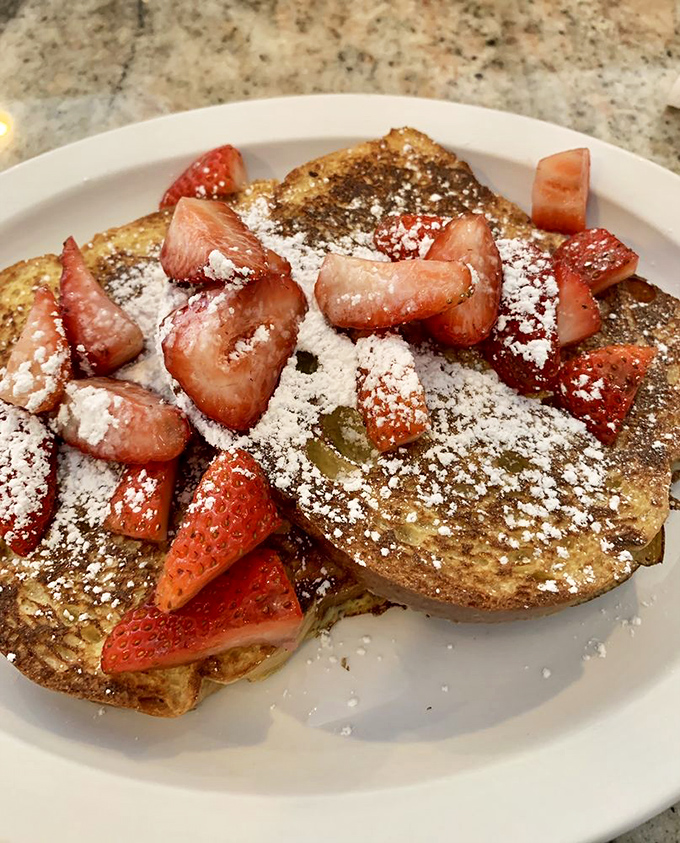French toast that puts ordinary bread to shame. Those strawberries aren't garnish&mdash;they're participating in a breakfast masterpiece.