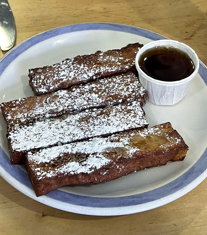 French Toast Sticks that look like they've been dusted with powdered sugar snow, waiting to take a maple syrup bath.