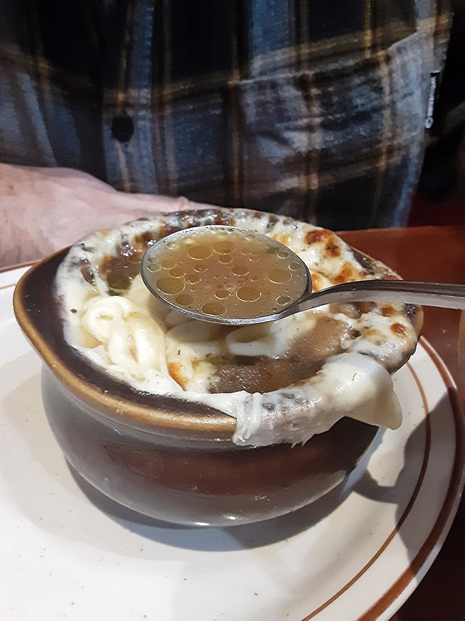 French onion soup that's worth the cheese pull&mdash;a bubbling cauldron of savory broth crowned with a magnificent melted canopy.
