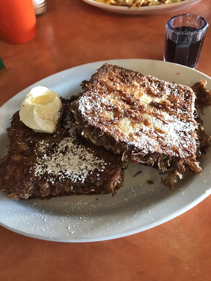 French toast that makes pancakes jealous. Perfectly caramelized exterior, custardy interior, and a dusting of powdered sugar for that "why not?" factor.