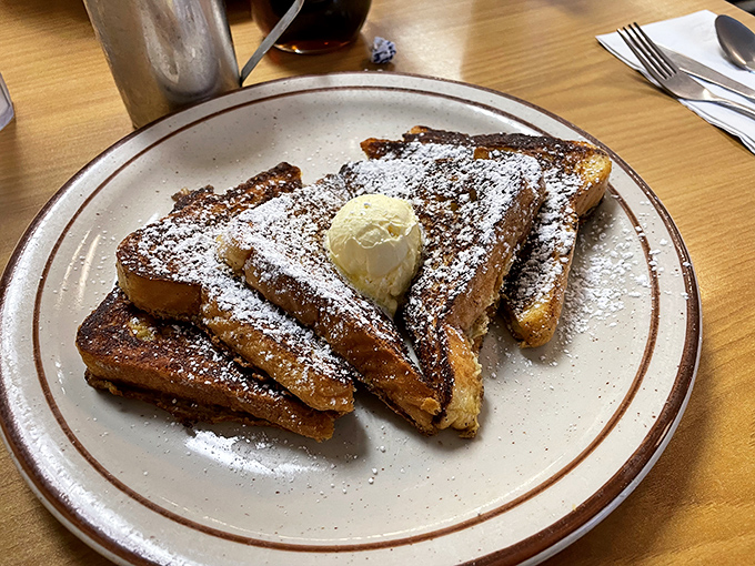 French toast dusted with powdered sugar and topped with a melting pat of butter&mdash;breakfast masquerading as dessert, and nobody's complaining.