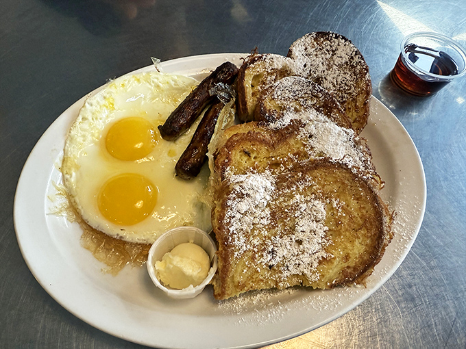 French toast that's had a proper education&mdash;powdered sugar, sunny-side-up eggs, and sausage links that snap when you bite them. Breakfast doesn't get more photogenic than this.