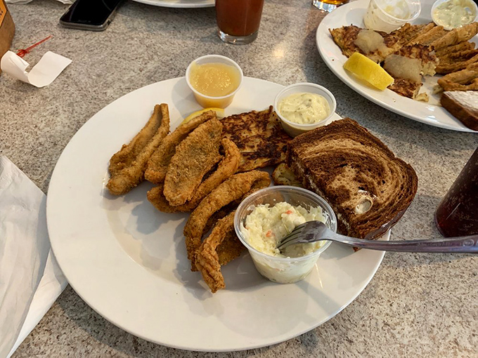 The Friday fish fry arrives golden and glorious, with that perfect trio: crispy fish, marbled rye, and creamy coleslaw. Wisconsin on a plate.