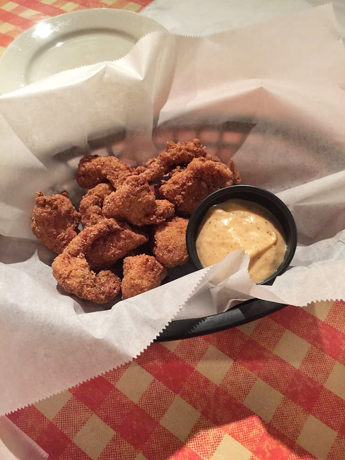 Bite-sized pieces of alligator nestled in paper &ndash; crispy, tender morsels that make you wonder why you haven't been eating reptile your whole life.