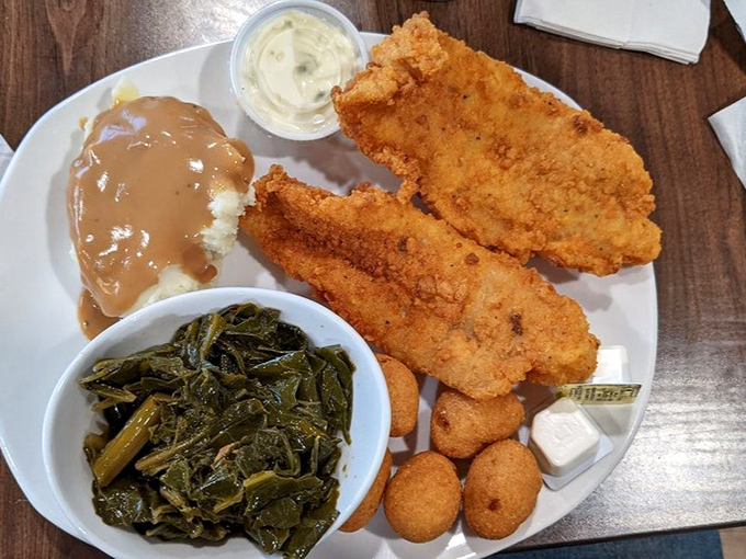 Golden-fried catfish with all the fixings. The kind of meal that makes you want to call your cardiologist just to brag.