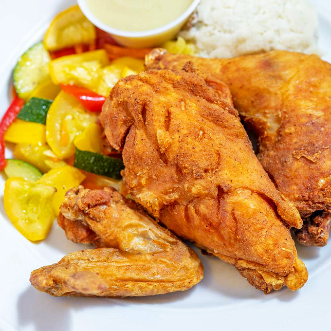 Fried chicken that's traveled through the perfect storm of seasonings before reaching crispy, juicy perfection alongside colorful vegetables.