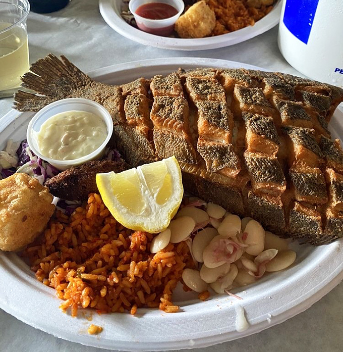 A perfectly scored flounder that's crispy outside, flaky inside. That red rice and slaw aren't just sides&mdash;they're essential supporting characters.