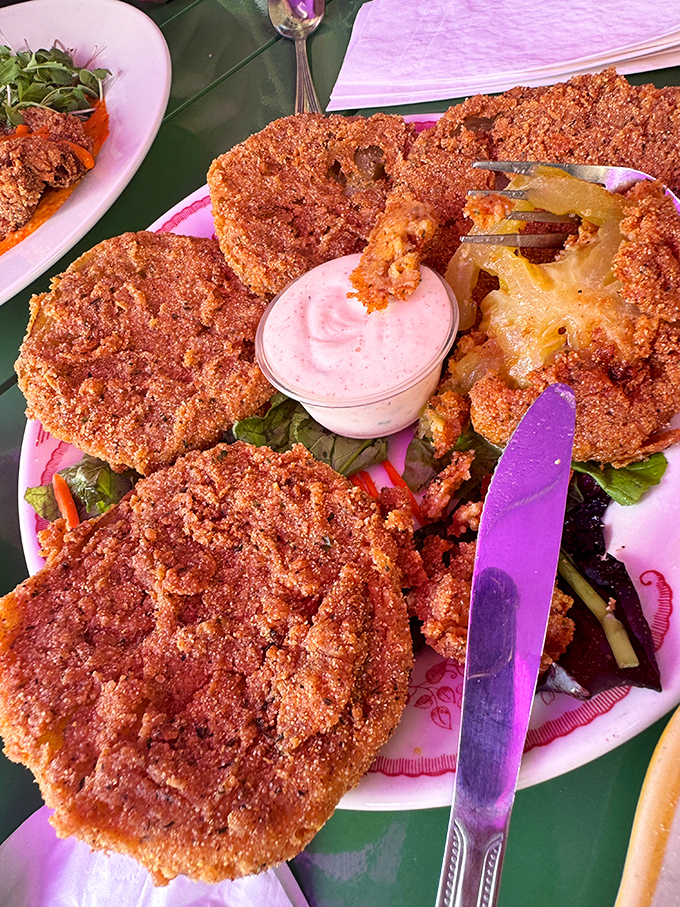 These fried green tomatoes aren't just Southern classics; they're crispy discs of tangy perfection that could convert even the most devoted tomato skeptic.