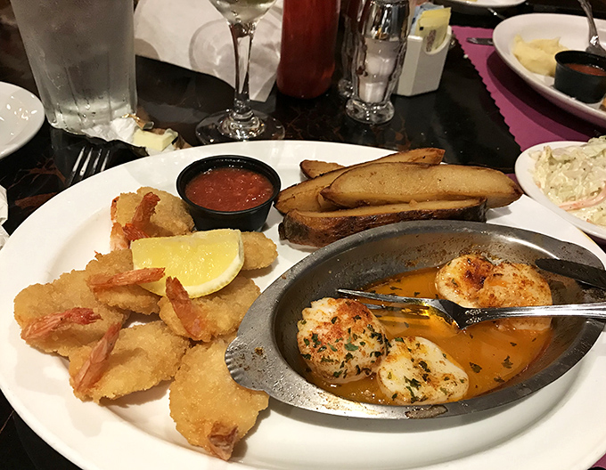 Ocean treasures on a plate: golden fried shrimp, buttery scallops, and potato wedges &ndash; proof that Pennsylvania understands seafood too.