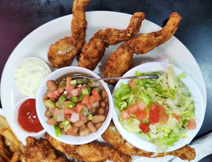 Crispy frog legs that would make even skeptics reconsider. Served with fresh sides that balance the richness perfectly.
