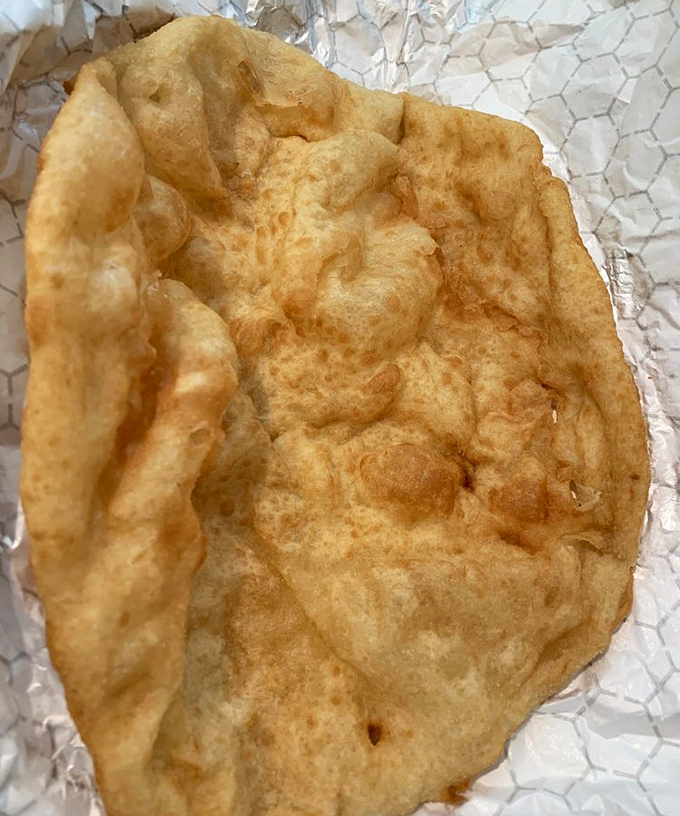 Perfection needs no adornment. This plain fry bread showcases the golden bubbles and crispy-yet-tender texture that makes it the star of the show.