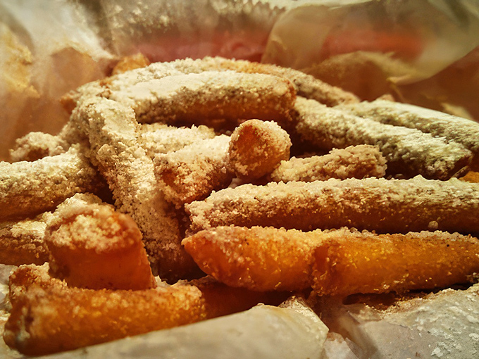 Funnel cake fries dusted with powdered sugar&mdash;where carnival nostalgia meets everyday indulgence in a hand-held, dippable format.