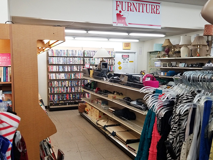 The furniture section sign looms above a wonderland of potential. Where else can you find DVDs, lamps, and your next coffee table all in one aisle?
