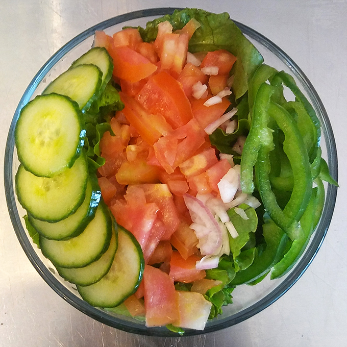 A garden salad that actually looks like it came from a garden&mdash;crisp cucumbers, juicy tomatoes, and greens arranged with the care usually reserved for dishes costing four times as much.