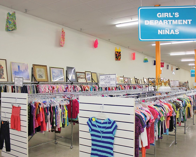 The girls' department proves that kids' fashion doesn't have to cost a fortune. Tiny dresses hang like colorful flags, signaling the victory of thrift over retail.