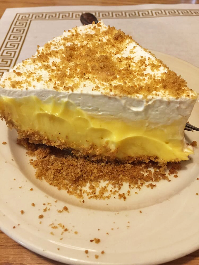 This graham cracker pie with its towering meringue is what dessert dreams are made of. Cloud-like topping, sunshine-yellow filling, happiness on a plate.