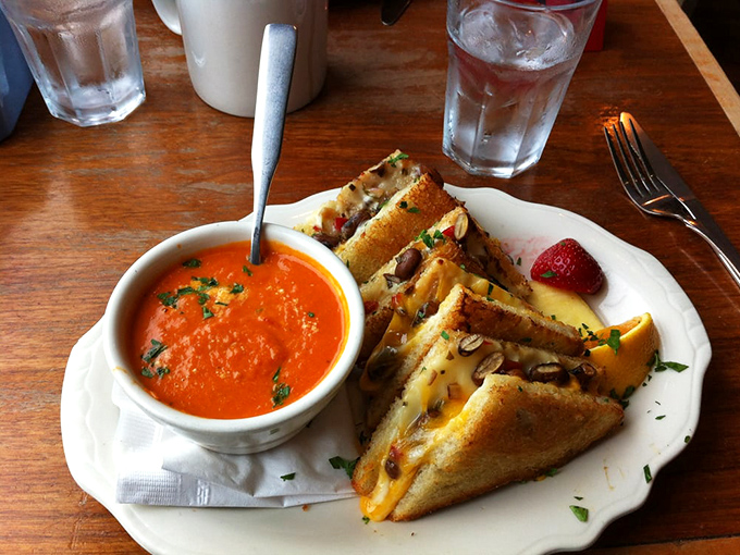 Grilled cheese and tomato soup: childhood nostalgia elevated to art form. That golden-brown exterior promises the perfect cheese pull with every bite.