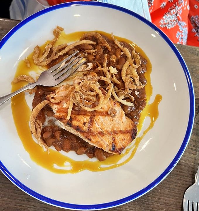 When salmon meets beans in this flavor symphony, you'll understand why some land-based dishes deserve equal billing at a seafood joint.