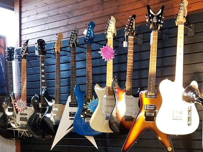 Rock star dreams line the wall! Each guitar tells a silent story of garage bands, campfire songs, and that one friend who always played "Stairway to Heaven."