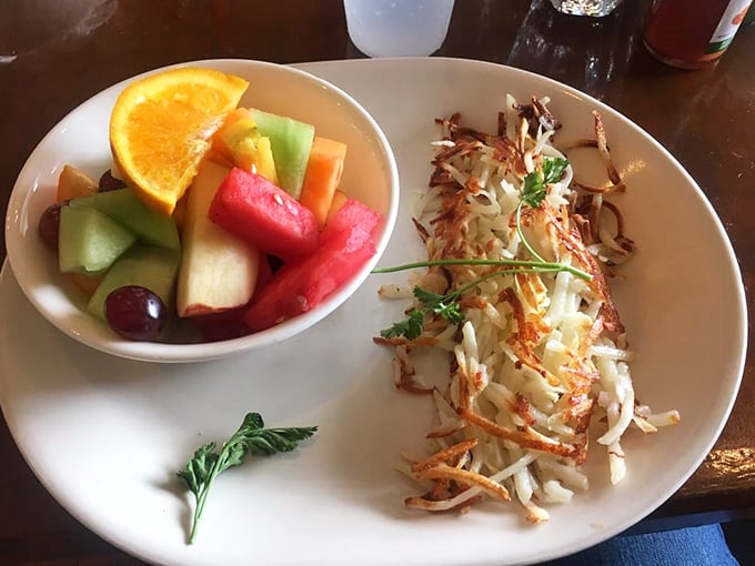 Fresh fruit bringing a pop of color and virtue to a plate of hash browns&mdash;nature's way of saying "balance is everything."