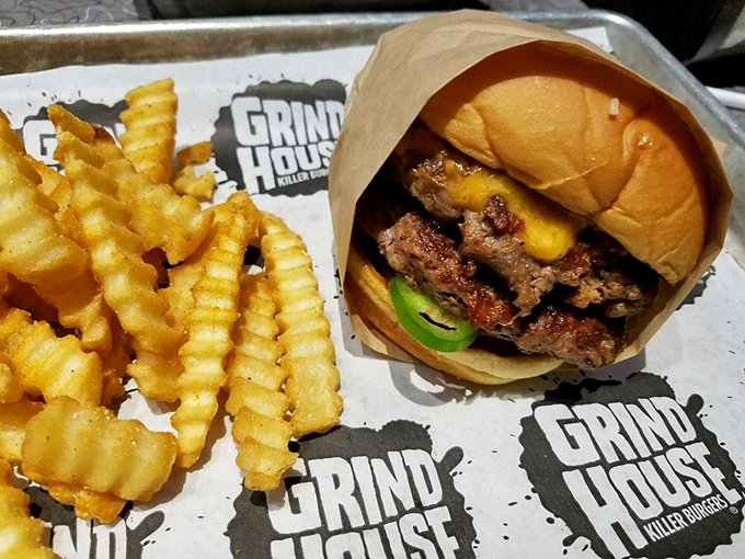 The Hillbilly Burger sits alongside golden crinkle fries – a dynamic duo that makes you wonder why you'd ever eat anything else.
