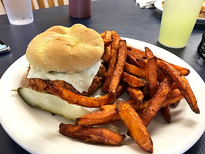A sandwich that means business, flanked by sweet potato fries that could start their own fan club. This plate doesn't just satisfy&mdash;it conquers.